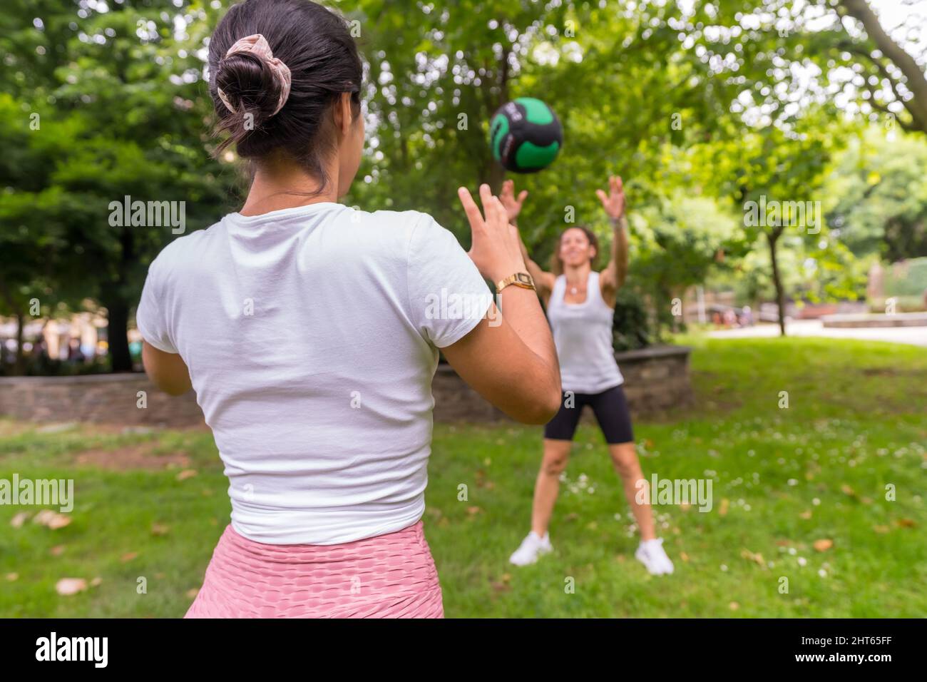 Women throwing a ball in a park on a sunny day Stock Photo - Alamy
