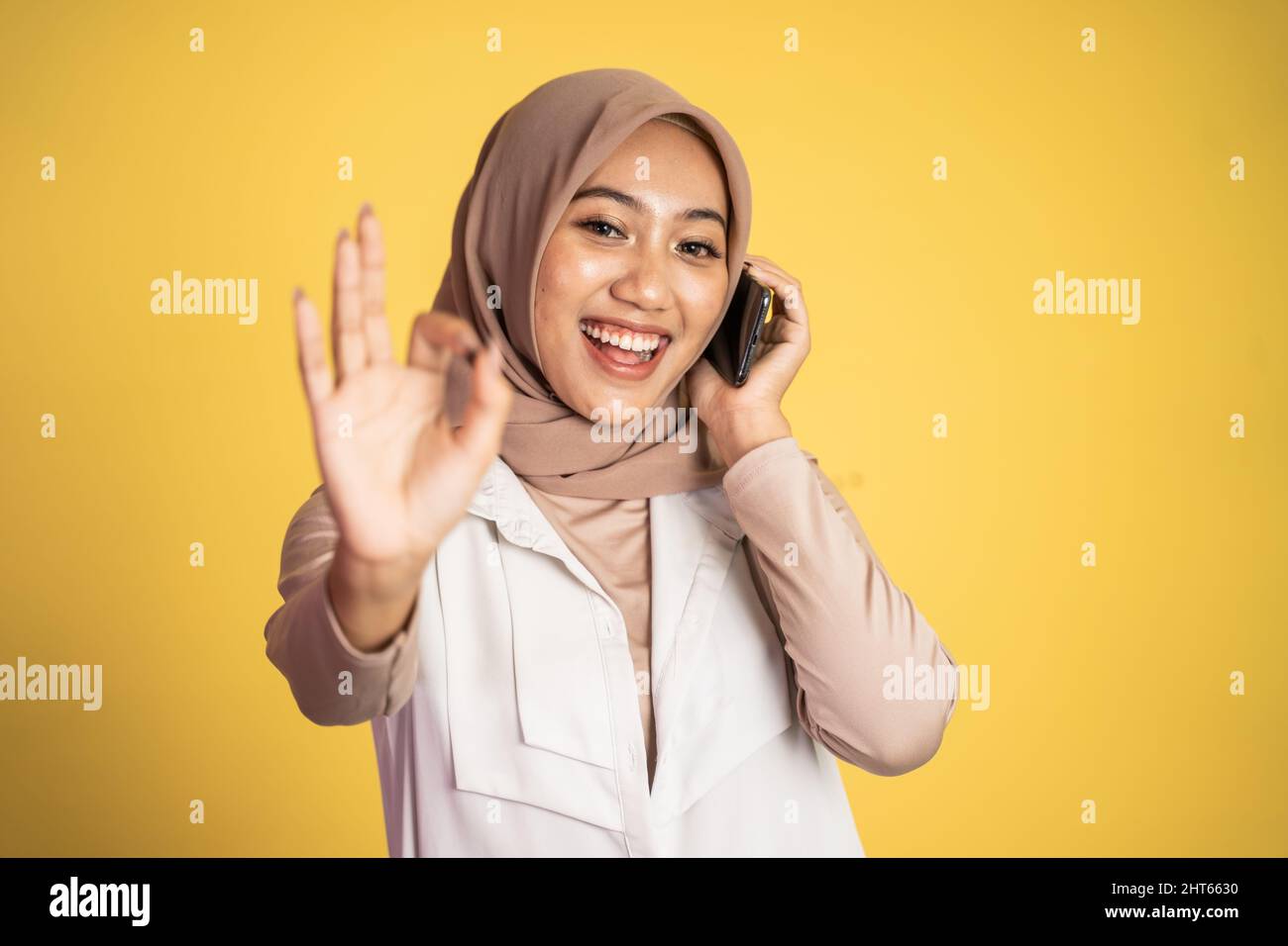woman making a call using a cell phone and showing thumb up Stock Photo ...