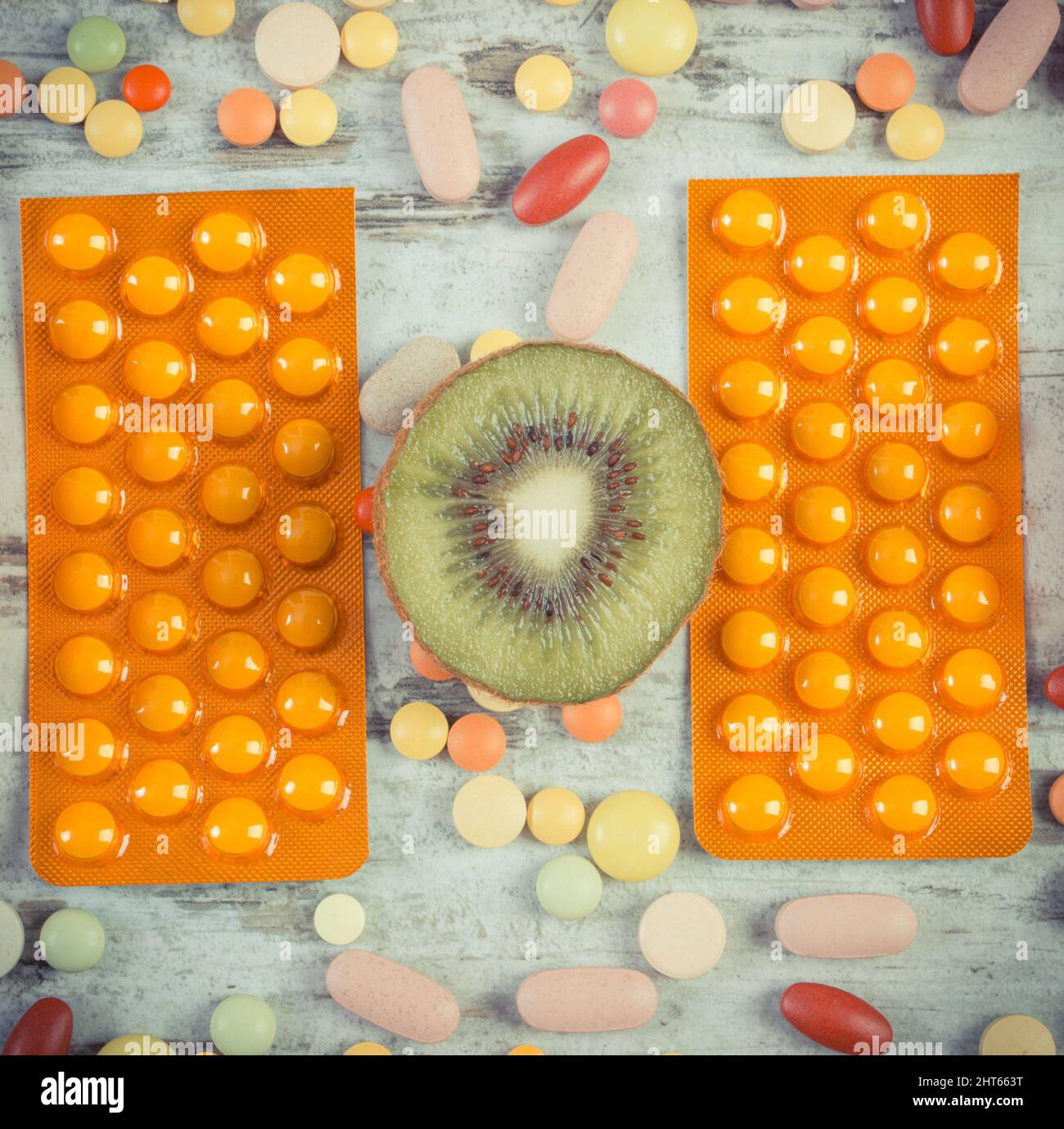 Fresh natural fruits and medical pills. Choice between eating fruits ...