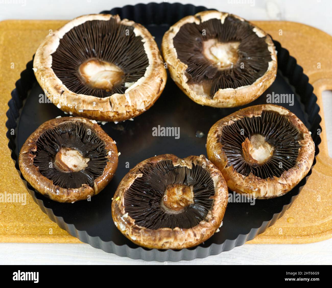 champignon mushrooms cooking process. raw Portobello on the plate ...