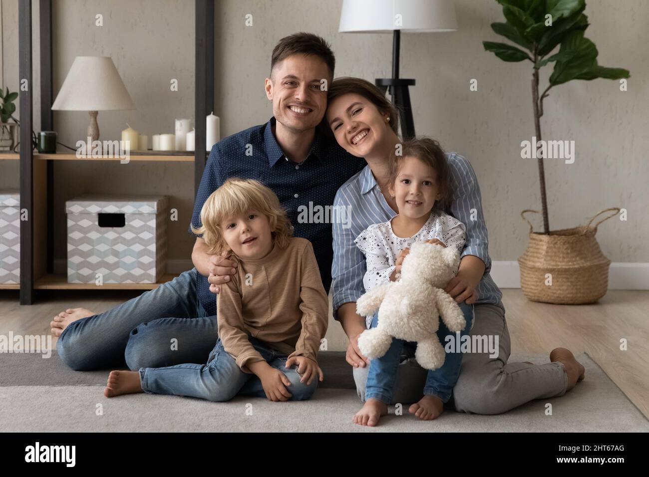 Portrait of happy loving young parents and little kids Stock Photo - Alamy