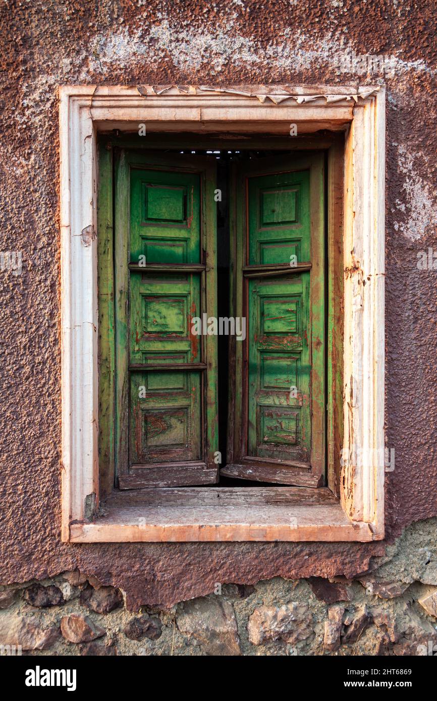 The old green window of the old stone house. Wooden wall background ...