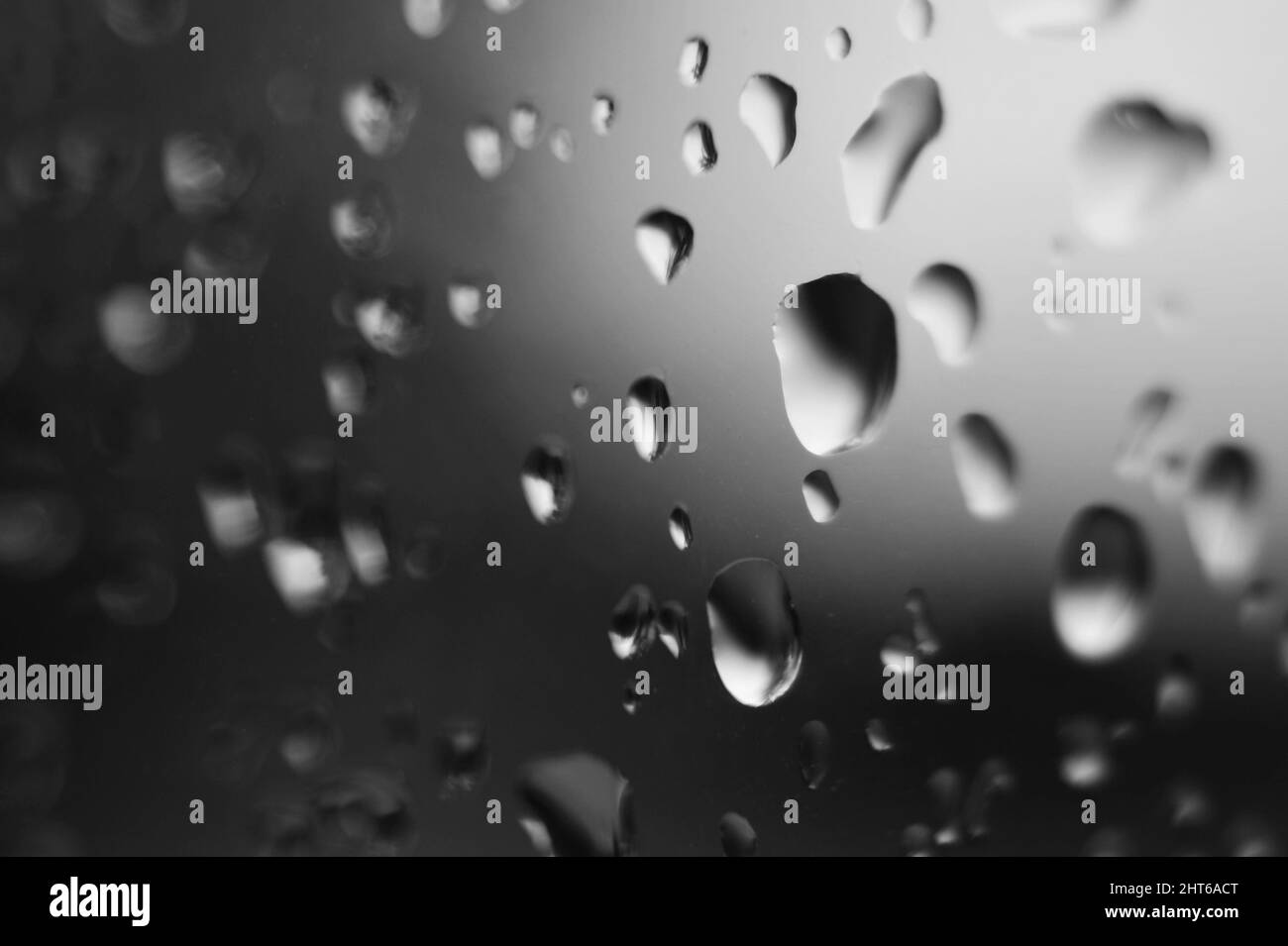 Graphic abstract of waterdrops backlit on a sheet of glass Stock Photo ...
