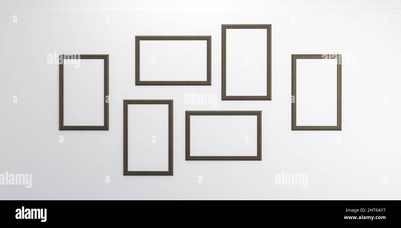 Empty wall with blank picture frames Stock Photo - Alamy