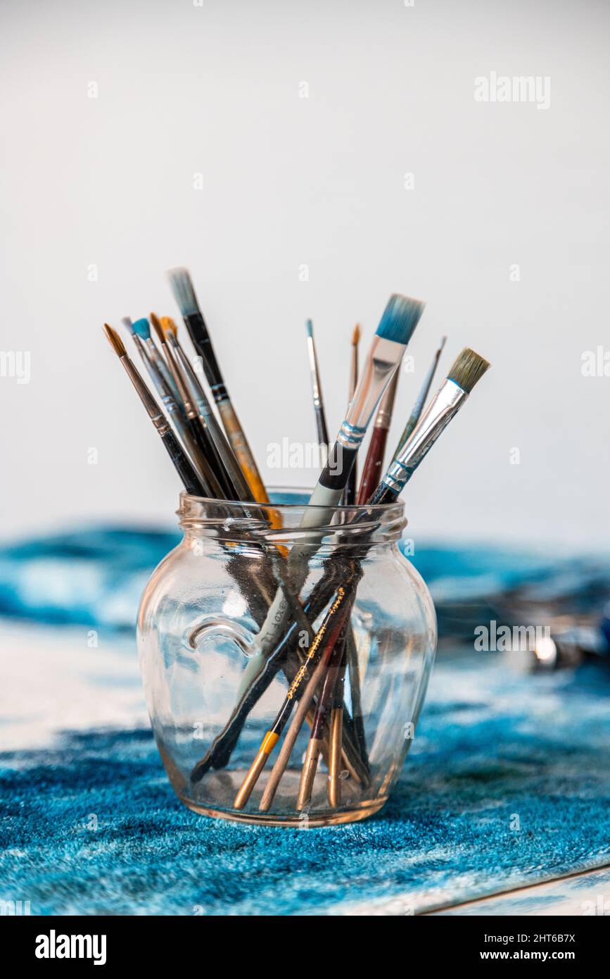 Paint brushes on the jar waiting to be used to create on white ...