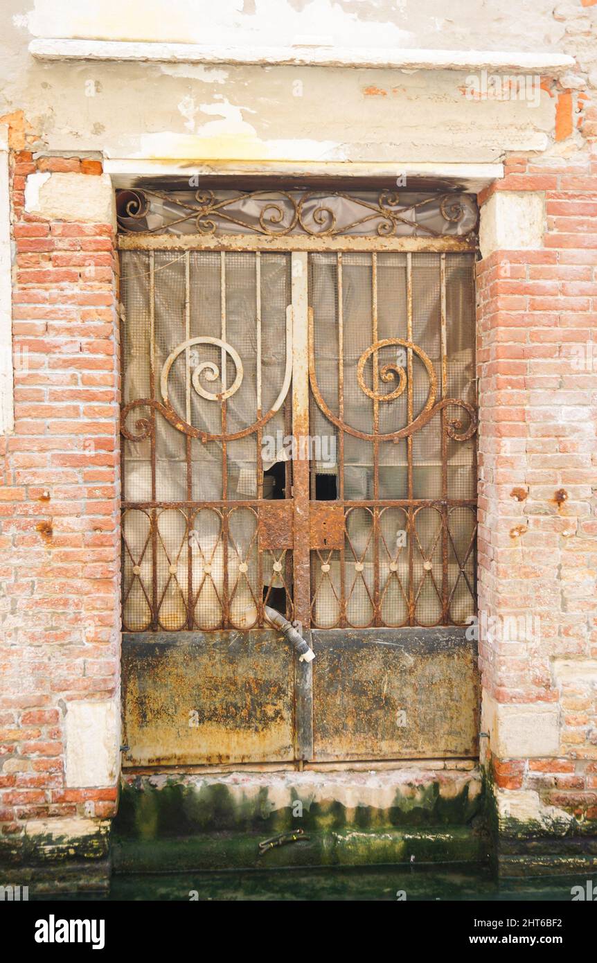 Vertical shot of an old gate of an old brick building Stock Photo - Alamy