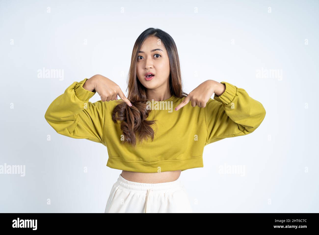 Asian beautiful woman makes gesture two fingers pointing below down ...