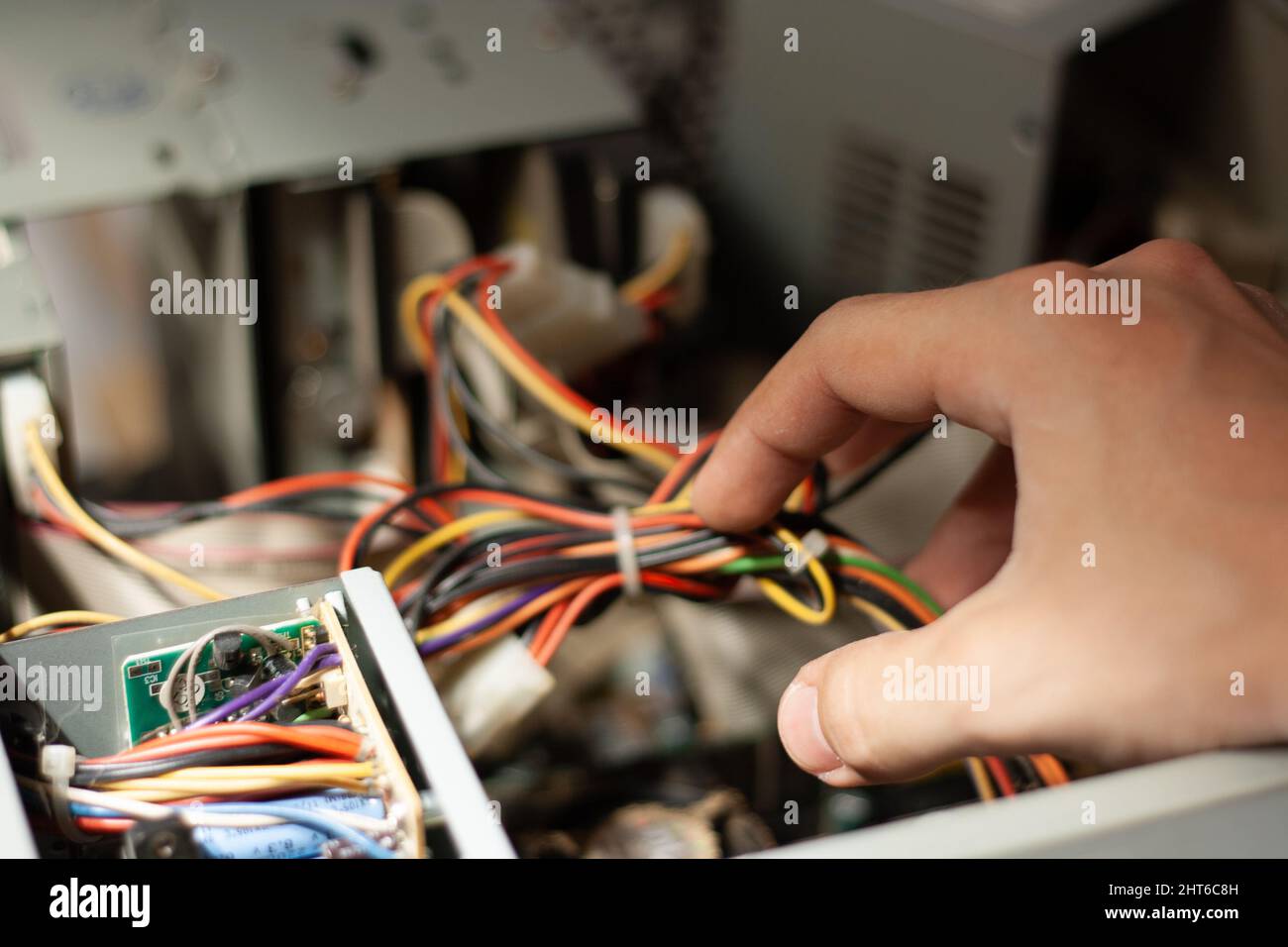 Photo of a person's hand repairing electric equipment Stock Photo - Alamy