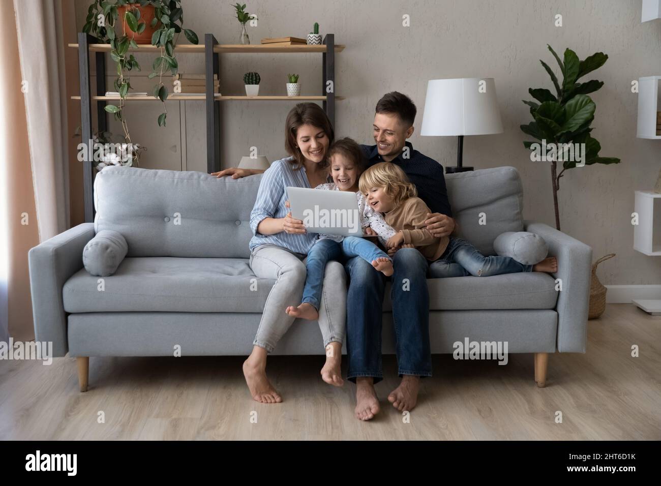 Happy affectionate family using computer applications Stock Photo - Alamy