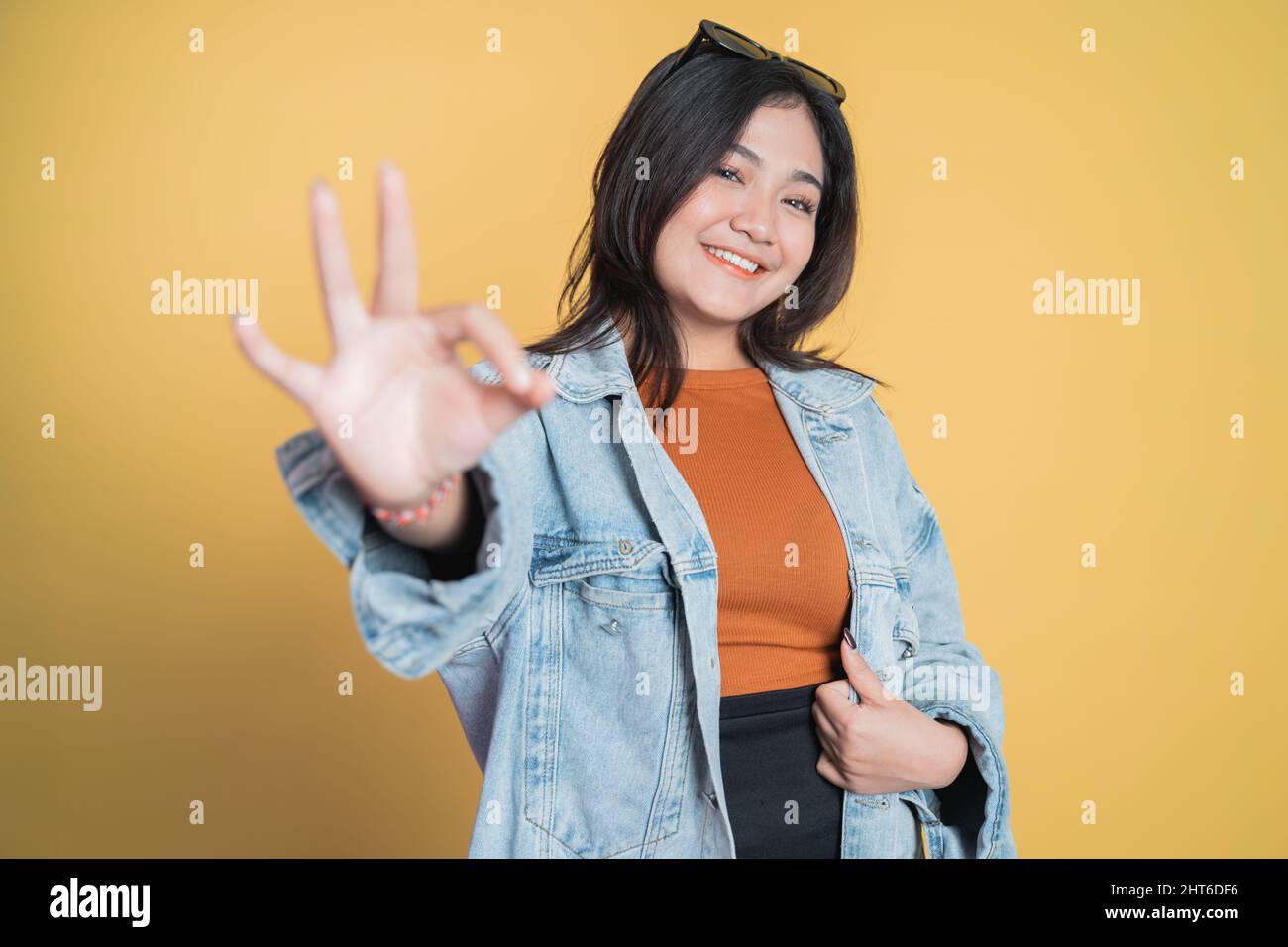 woman smiling with okay hand gesture on isolated background Stock Photo ...