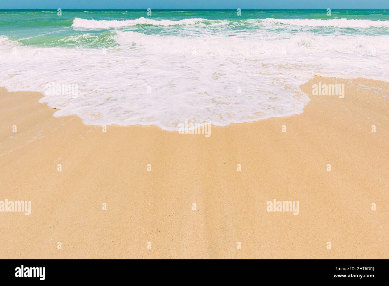 Ocean water foam splashes washing sandy beach. Amazing landscape ...