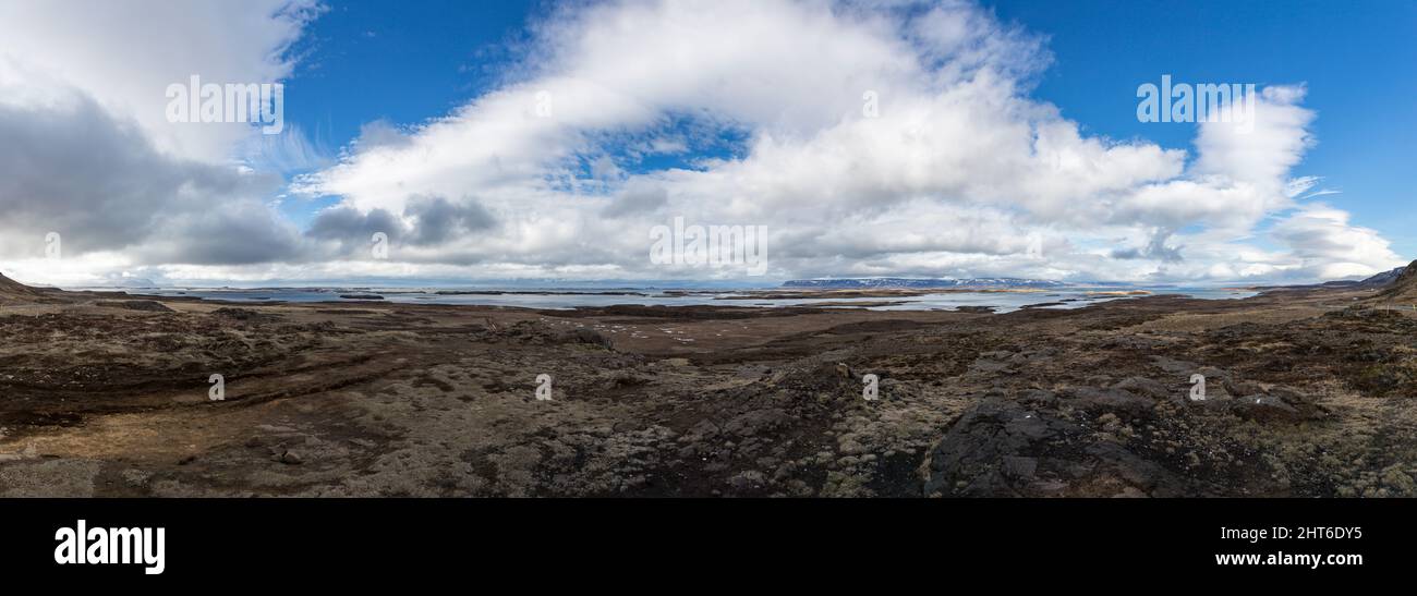 Panoramic scenery with clouds and blue sky over the raw coast of ...