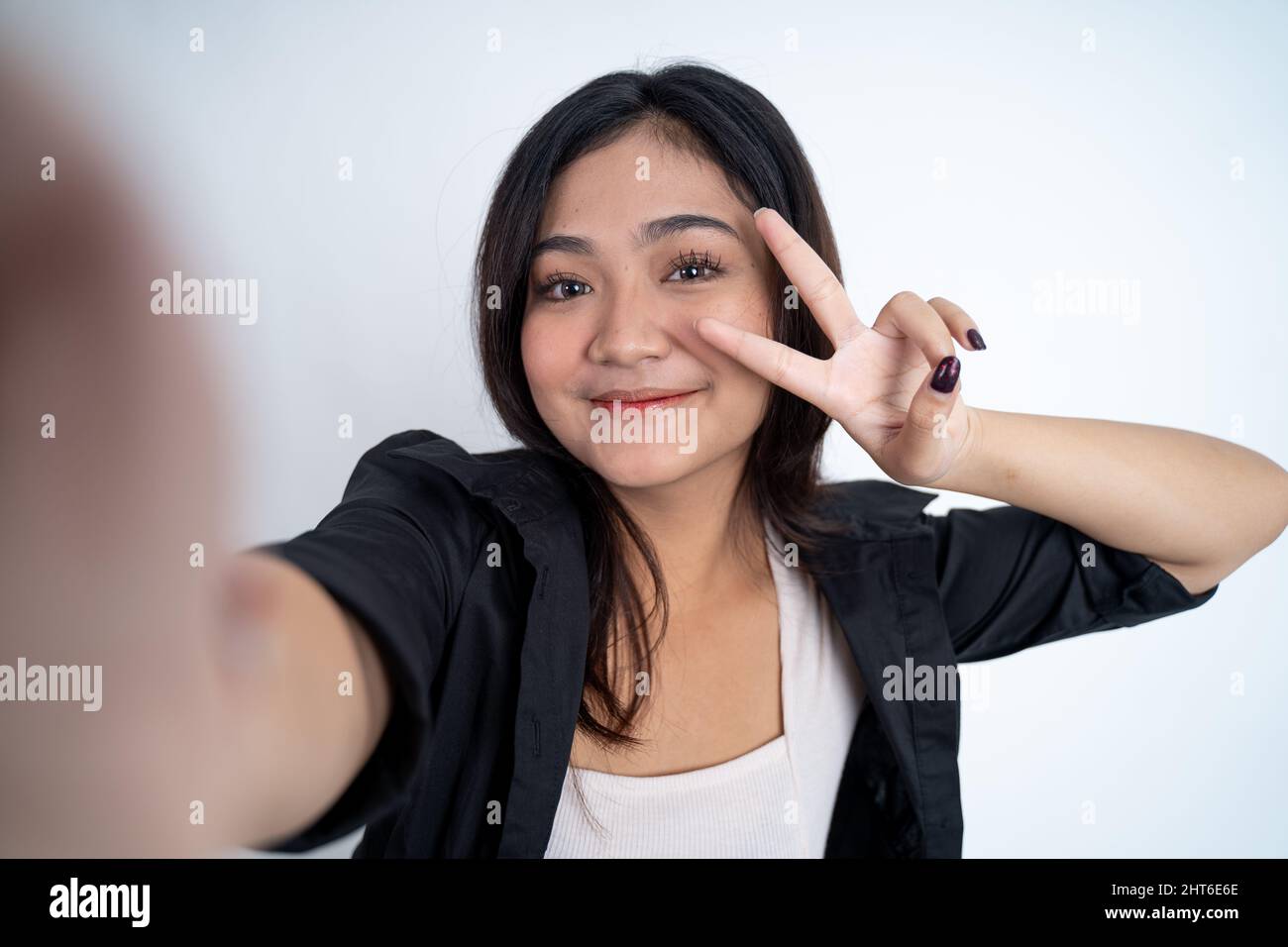 young woman selfie with peace sign finger gesture Stock Photo - Alamy