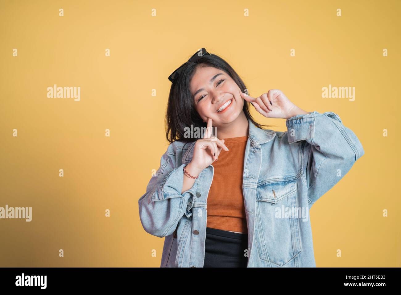 Finger pointing cheek hi-res stock photography and images - Alamy
