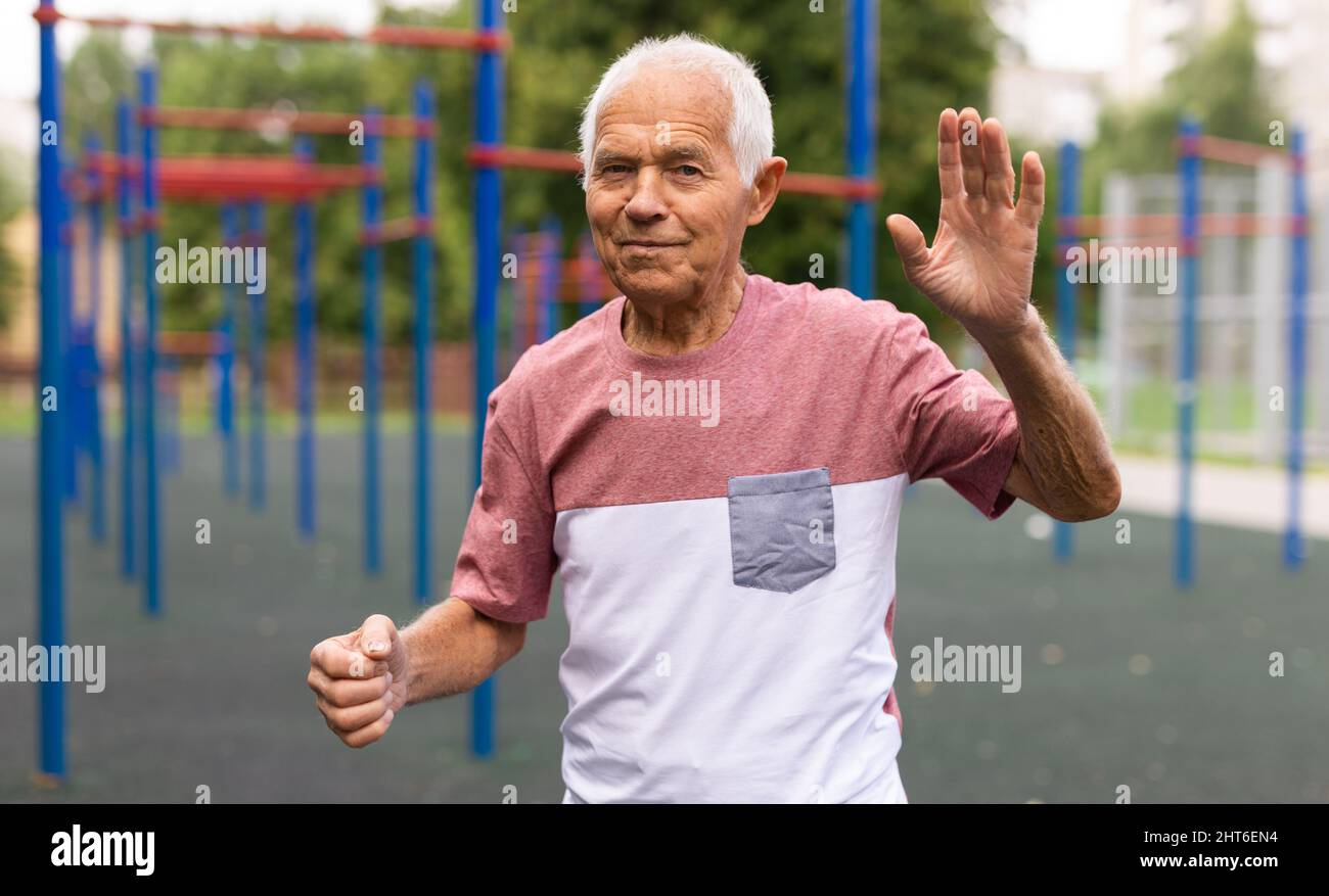 Senior man running on jogging track in nature. Healthy retirement ...