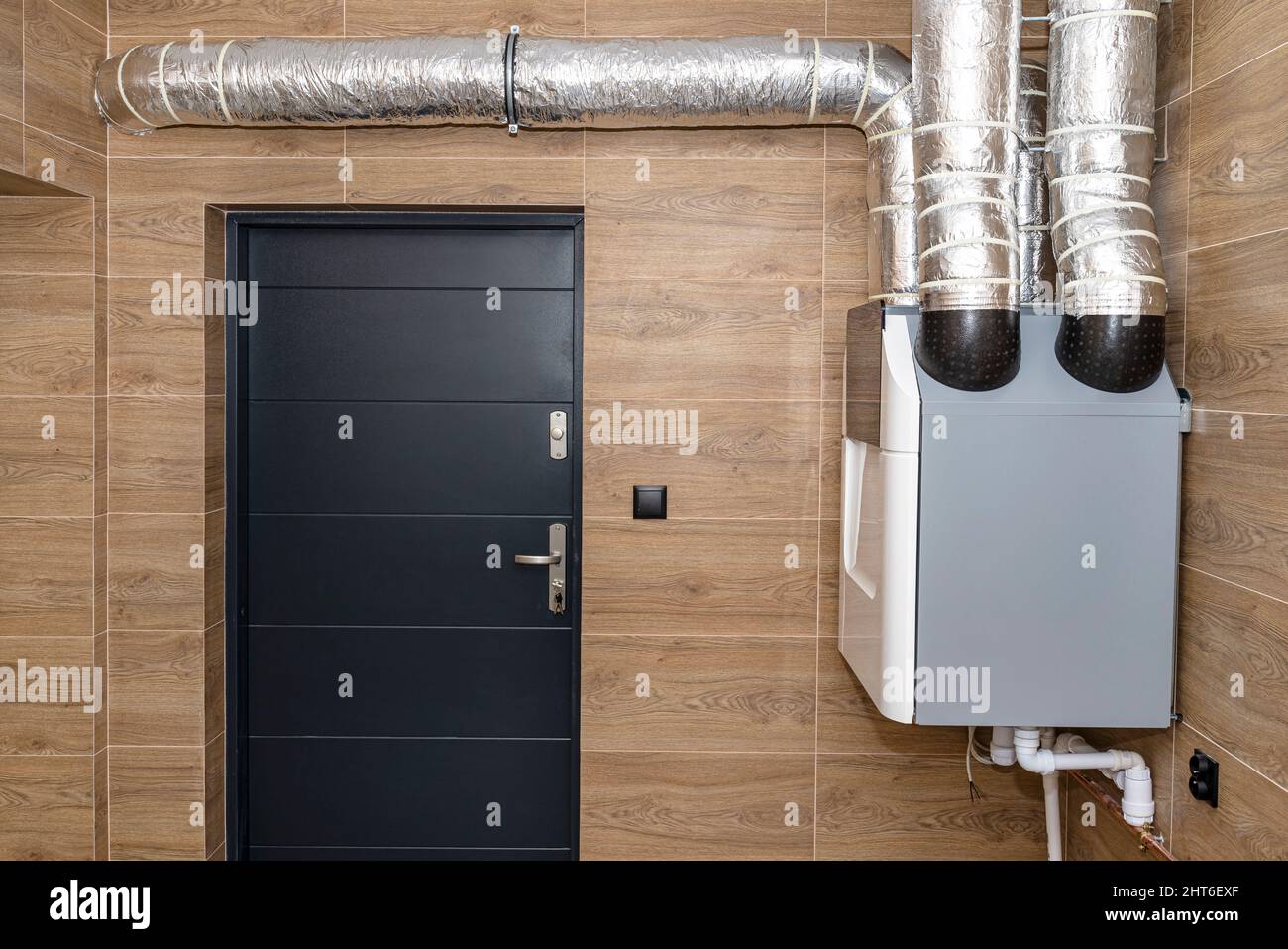 Home mechanical ventilation with heat recovery hanging on the wall in a ...