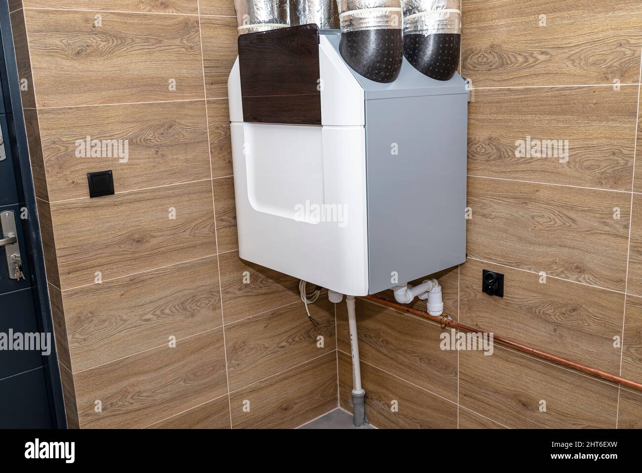 Home mechanical ventilation with heat recovery hanging on the wall in a ...