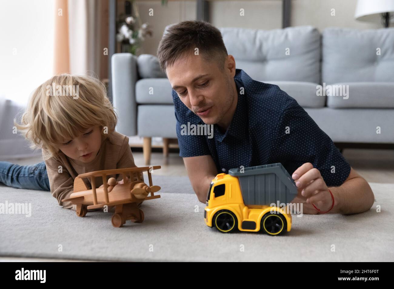 Happy young father playing toys with small kid Stock Photo - Alamy