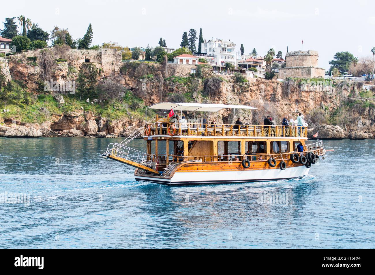 Antalya port tour boat with Hidirlik Tower on background Stock Photo ...