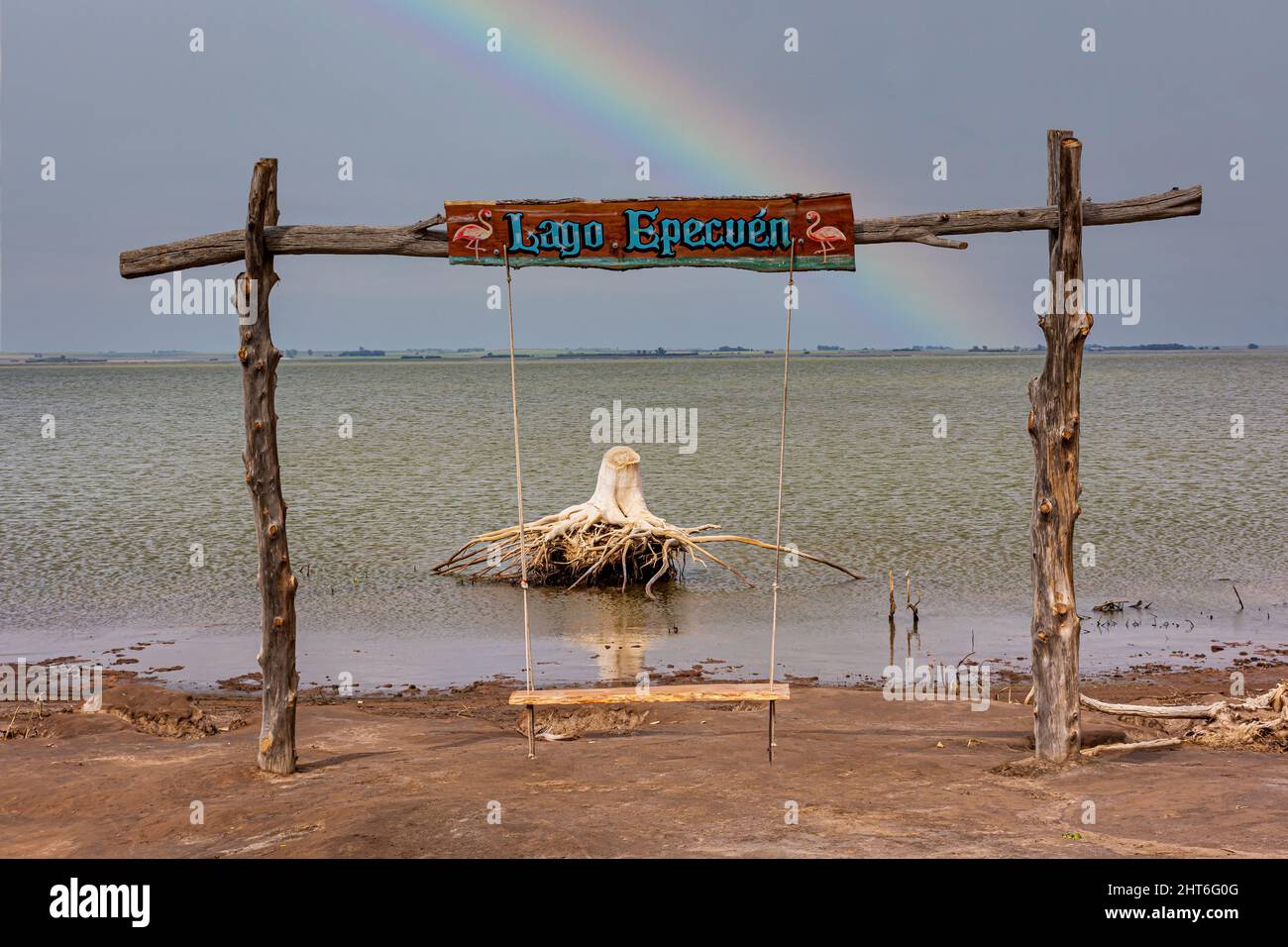Tree stump floating on the Lake Epecuen under a blue sky with a ...