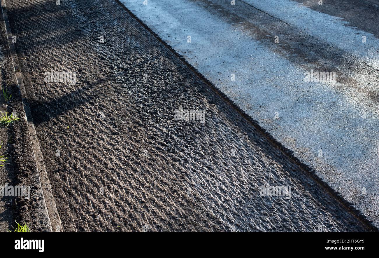 the milled surface of a damaged asphalt road prepared for ...