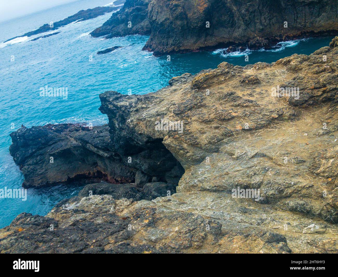 Closeup of an ocean with a rocky cliff in the foreground Stock Photo ...