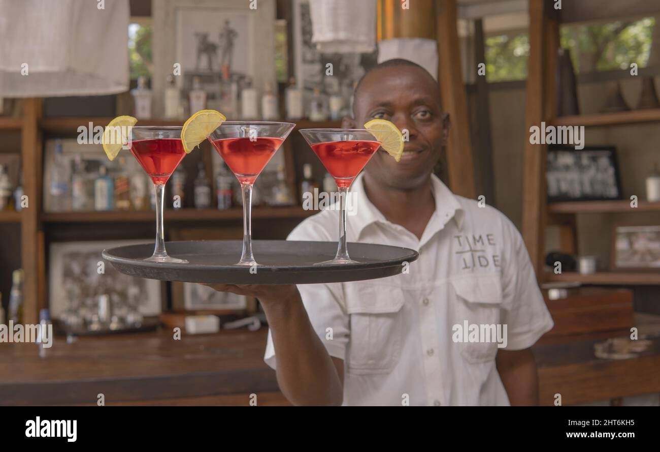 Black waiter serving cocktails in a hotel Stock Photo - Alamy