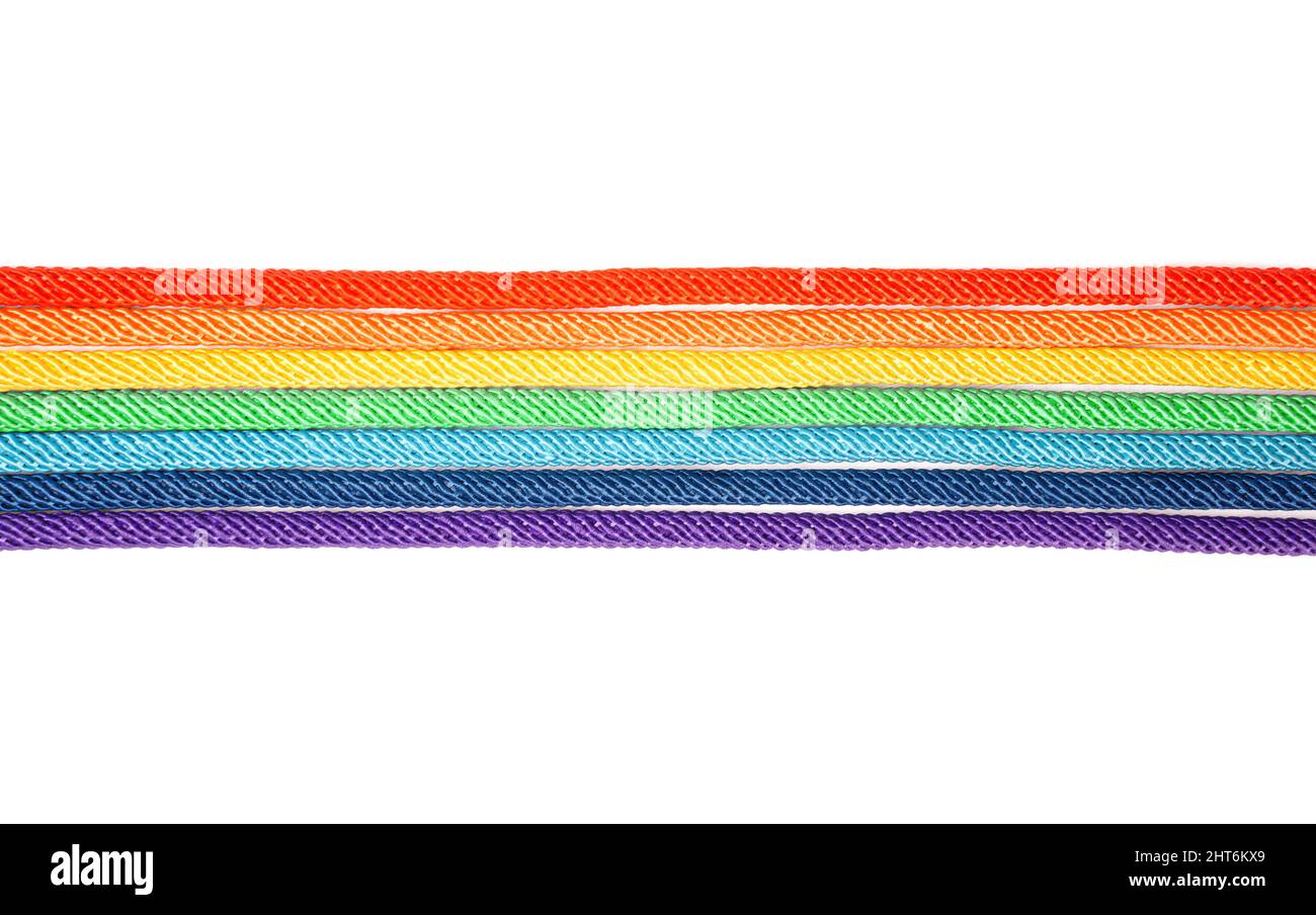 Seven rainbow dyed braided cotton cords isolated on white background ...