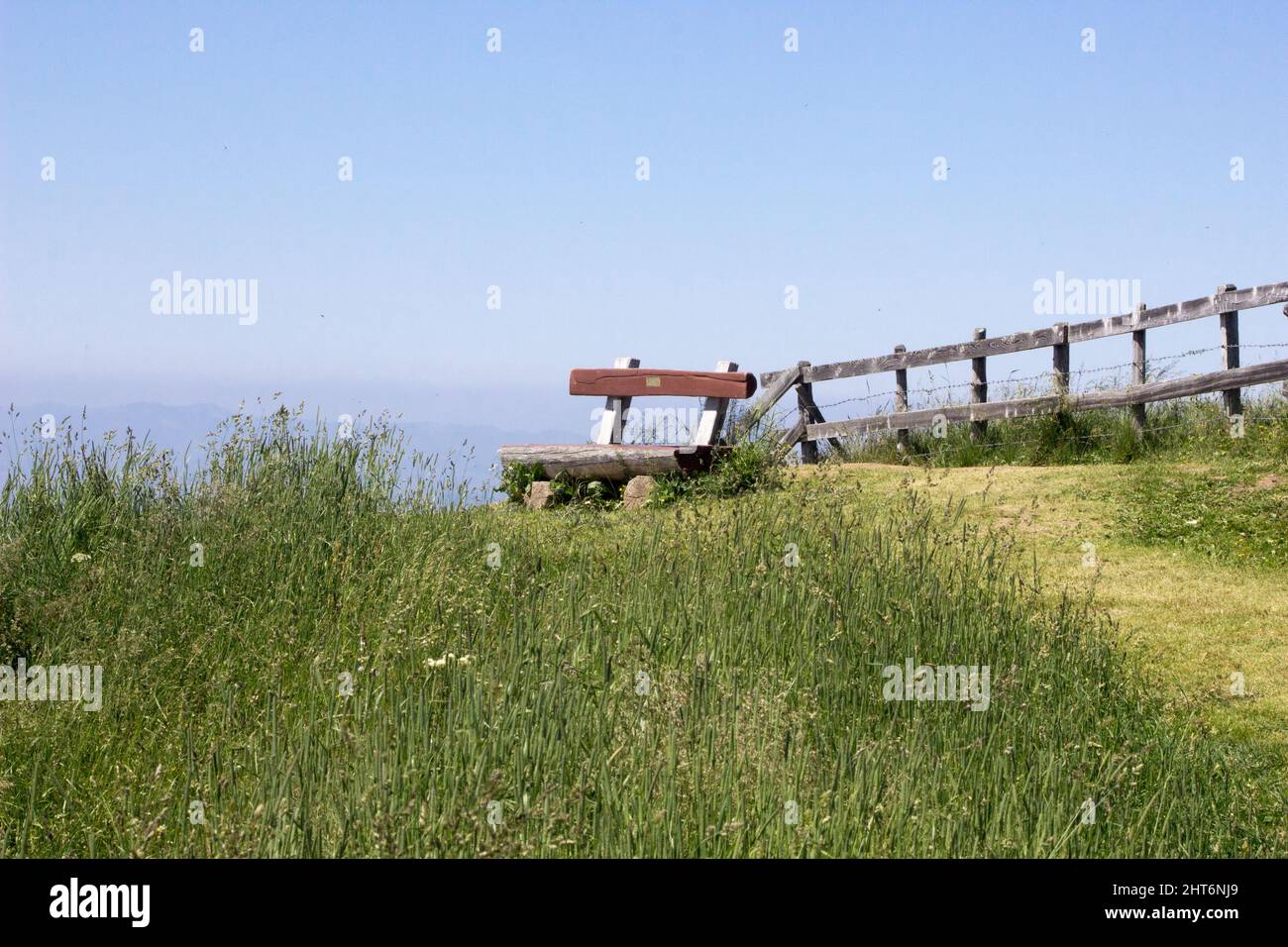 Wooden bench on the edge of a hill Stock Photo - Alamy