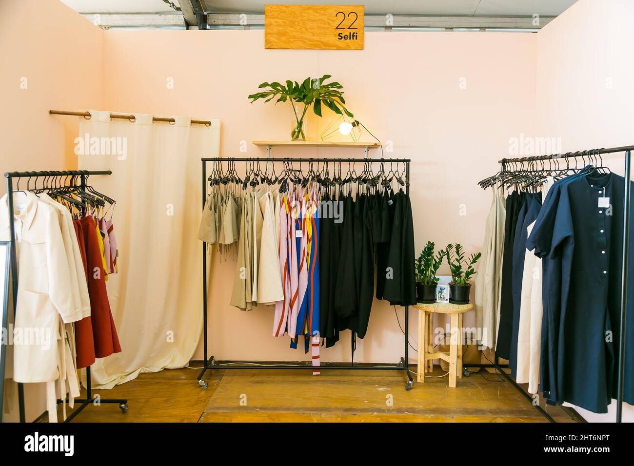 Clothes on display at exhibitor stand at hand-made design fair in ...