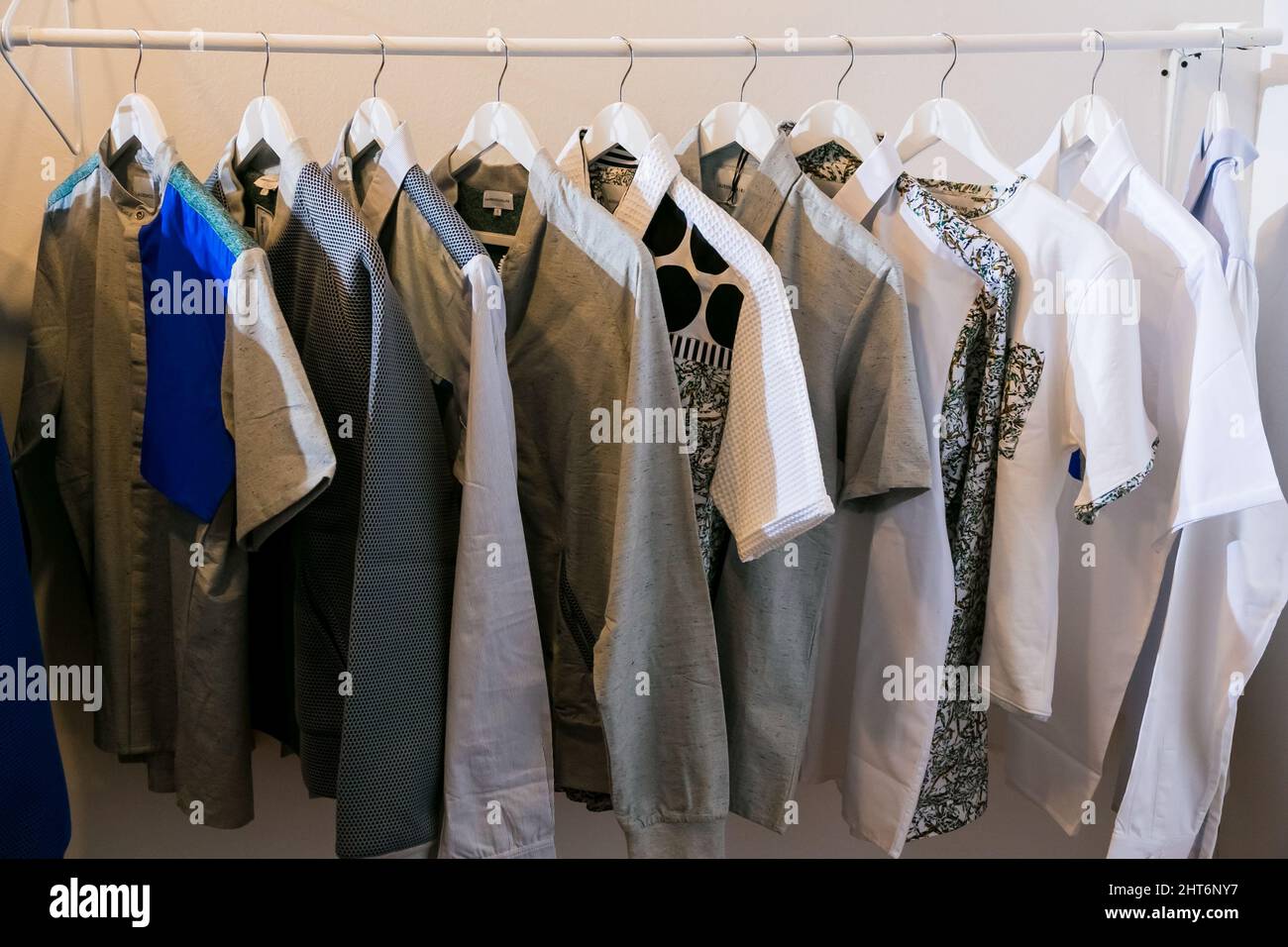 Clothes on display at exhibitor stand at hand-made design fair in ...