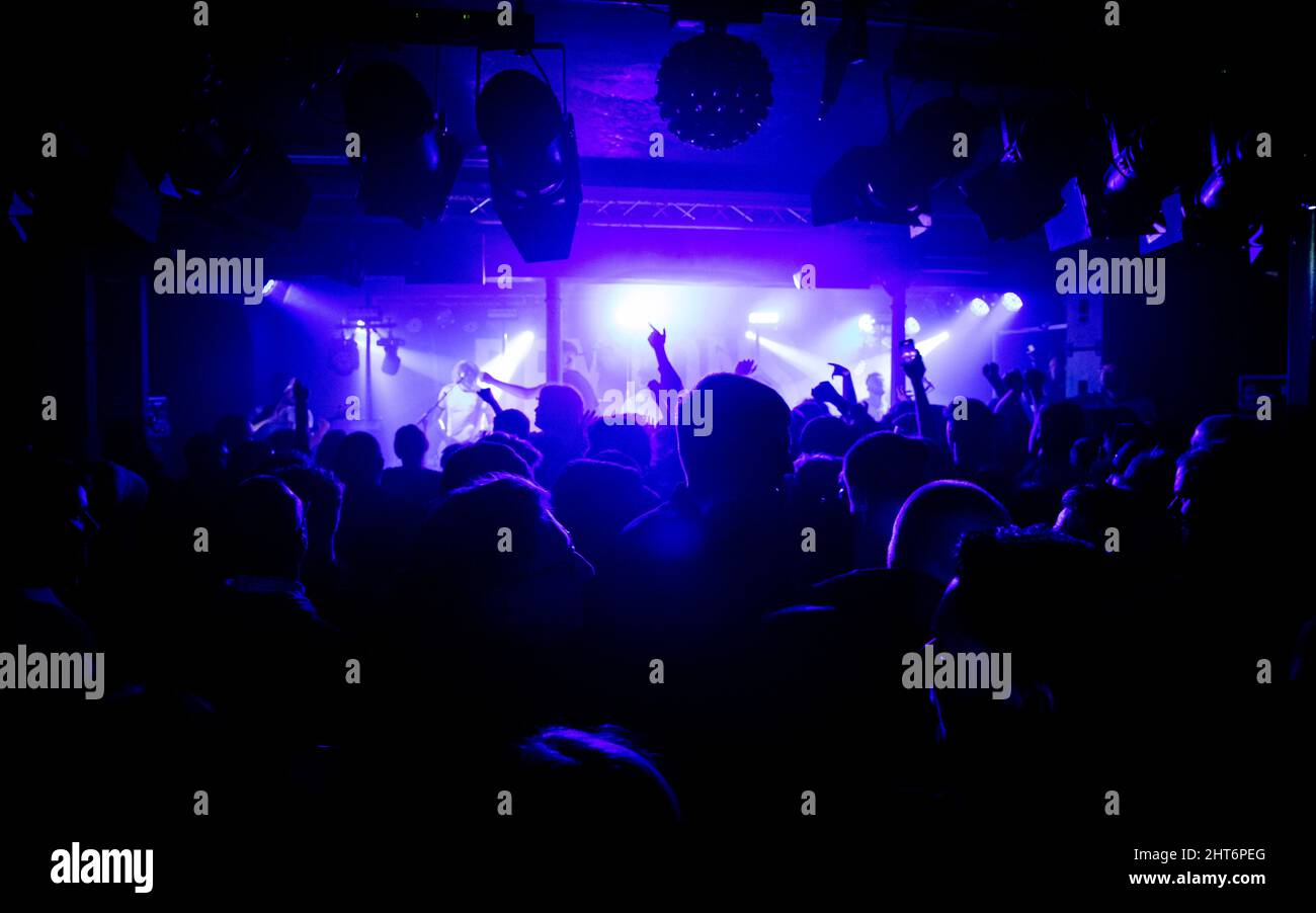 Crowd at a small venue gig with their hands up © Clarissa Debenham ...