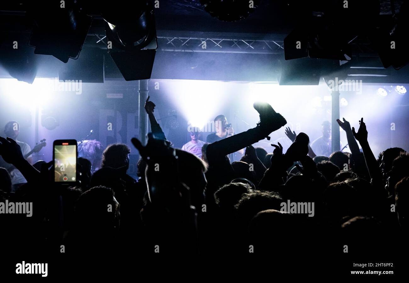 Crowd at a small venue gig with their hands up © Clarissa Debenham ...
