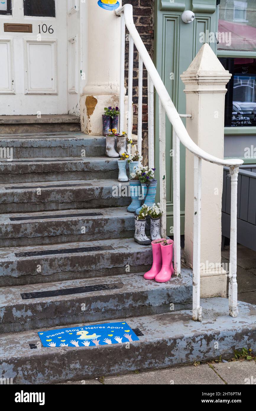 Front doorsteps with quirky plant pots made from colourful wellington ...