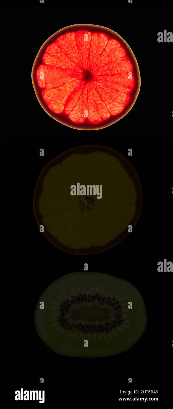 Red light on traffic light made of backlit slices of ripe citrus fruit ...
