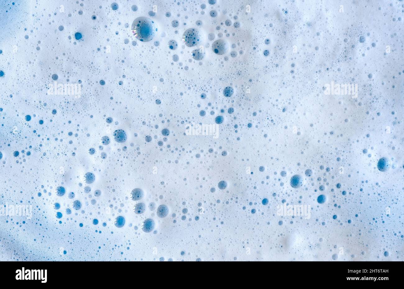 Soap cleanser foam bubbles texture on blue background Stock Photo - Alamy