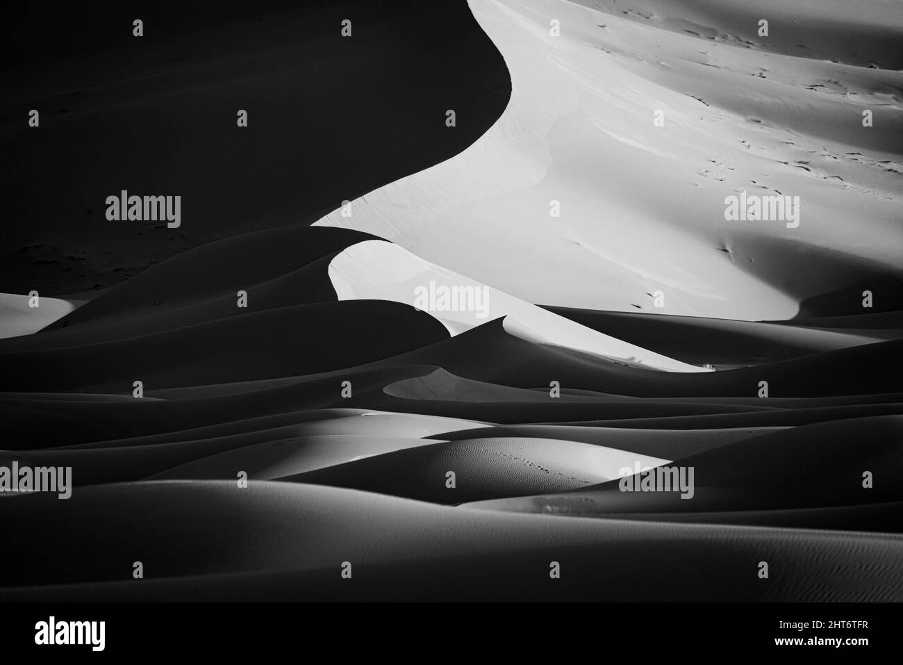 Grayscale shot of sand dunes of Sahara desert in Morocco Stock Photo ...