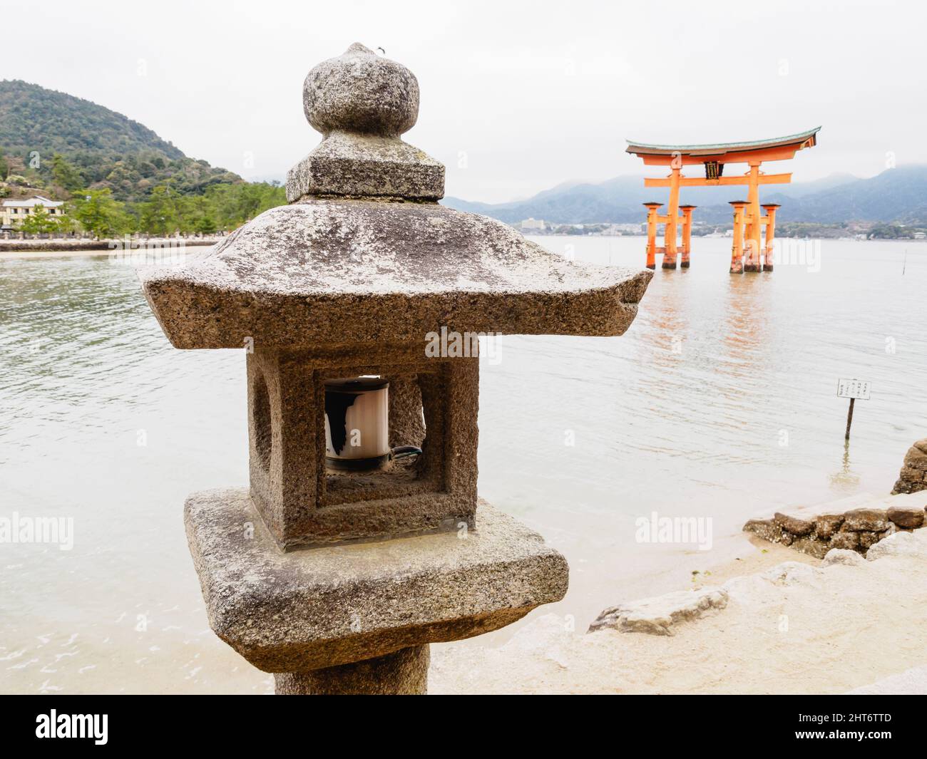 Famous Floating Torii gate behind stone lantern in Miyajima, Japan ...