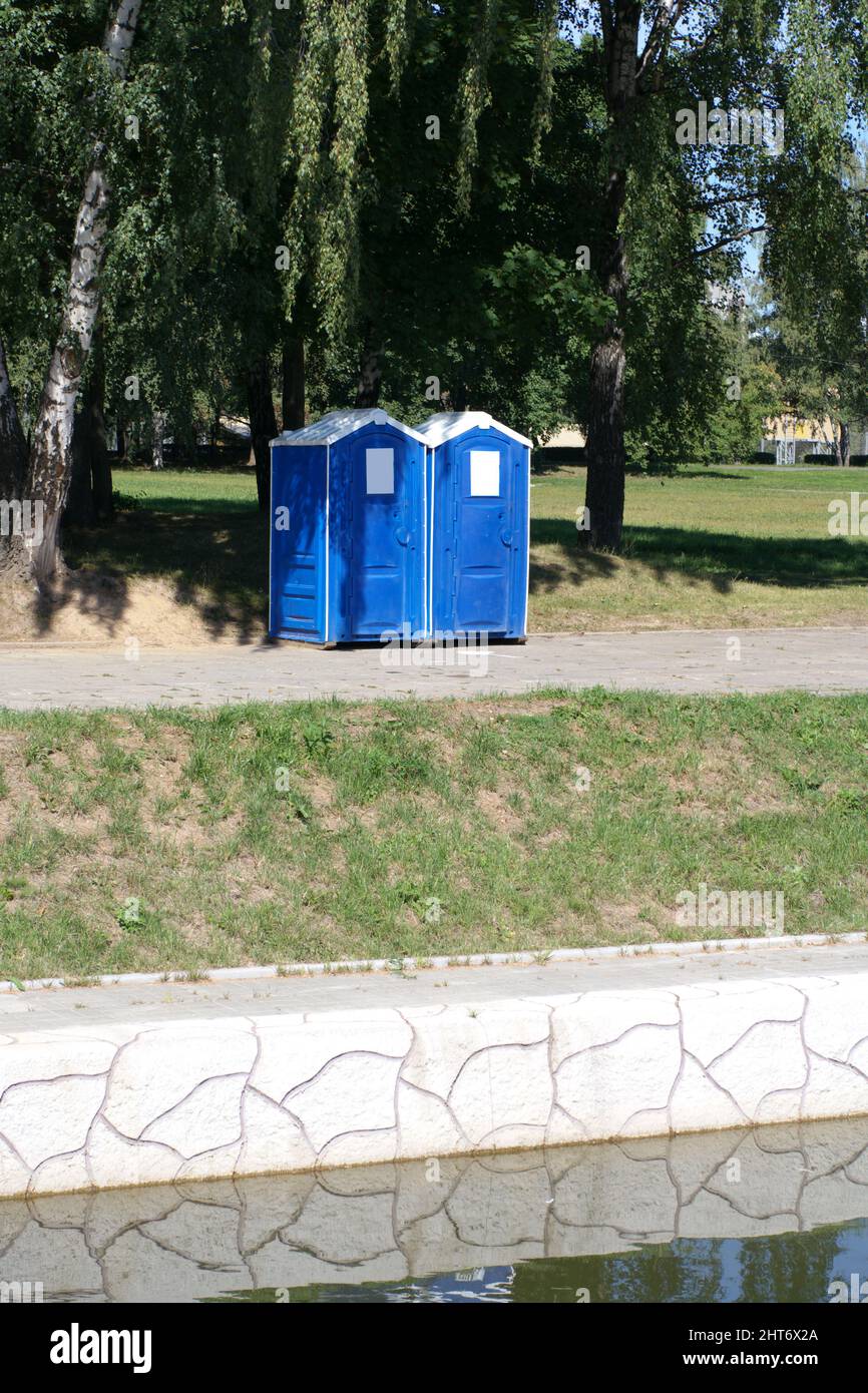 Two portable toilet cabins in park at dry sunny summer day Stock Photo ...