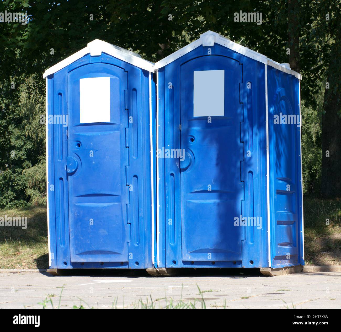 Two portable toilet cabins in park at dry sunny summer day Stock Photo ...