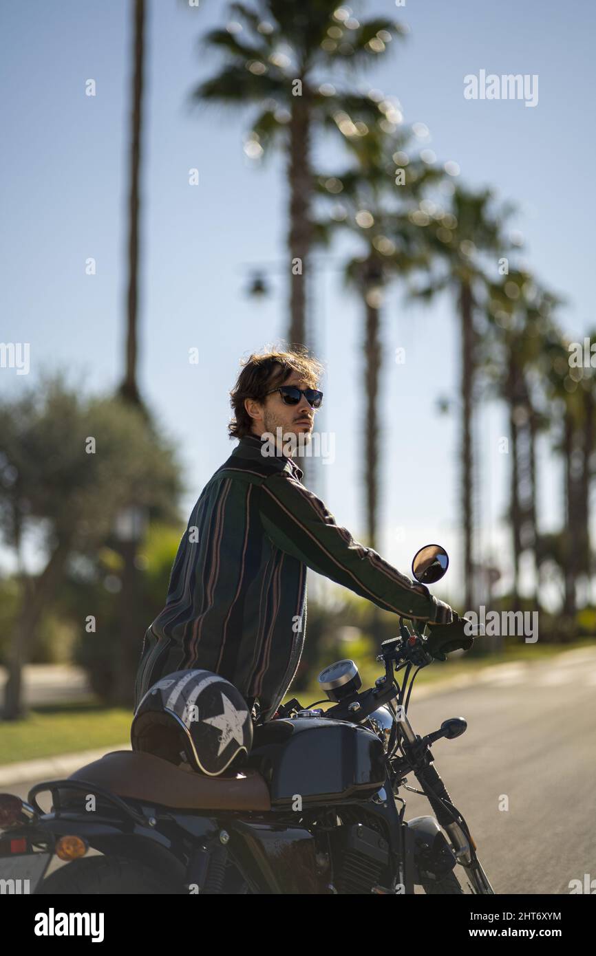Handsome guy near a motorcycle motorist posing in fancy clothes Stock ...