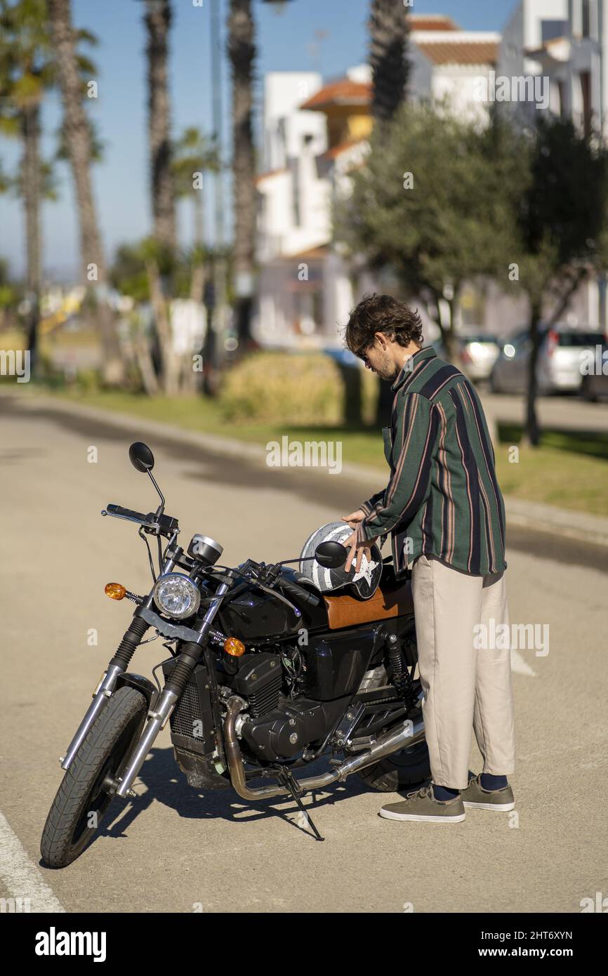 Handsome guy near a motorcycle motorist posing in fancy clothes Stock ...