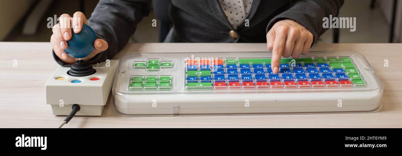 Woman with cerebral palsy works on a specialized computer mouse Stock ...