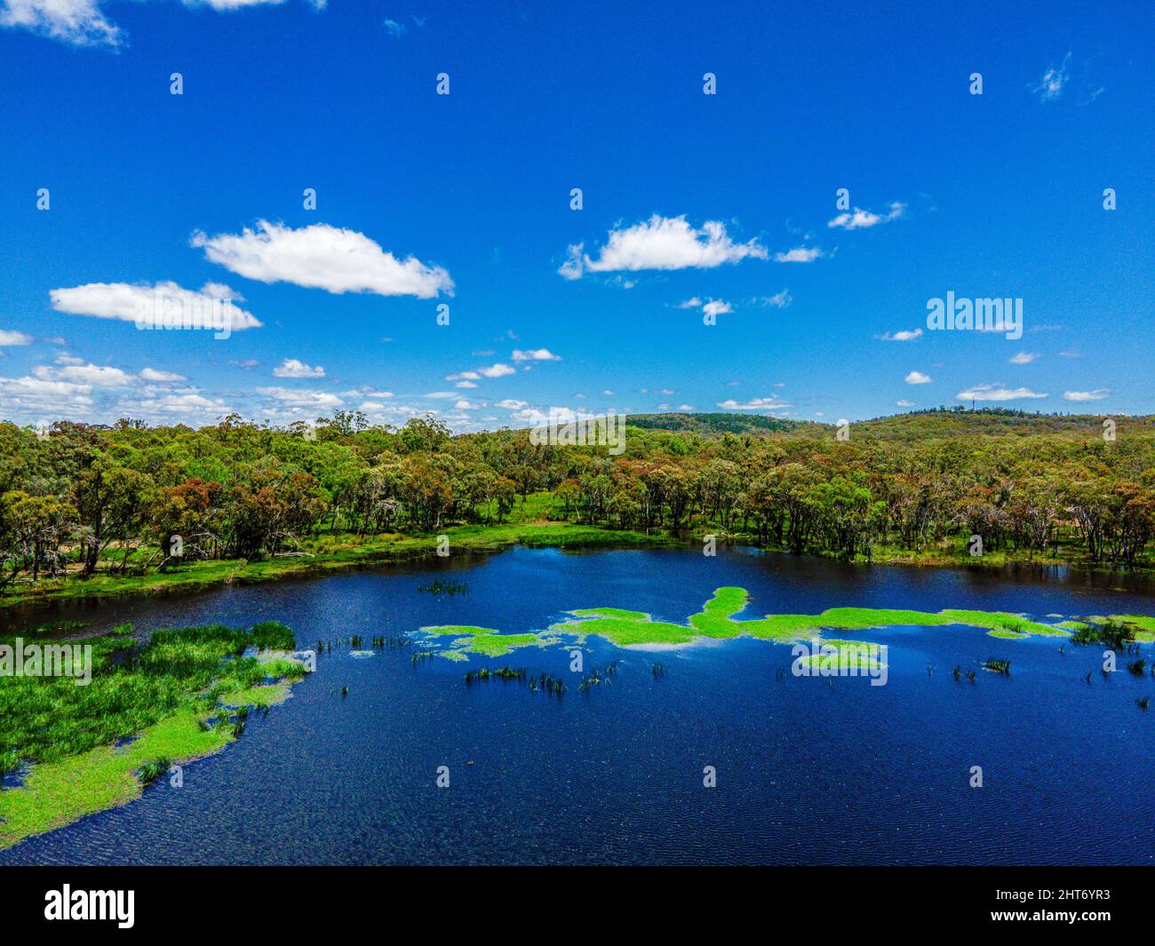 Beautiful aerial view of Emmaville with a small lake under a cloudy sky ...
