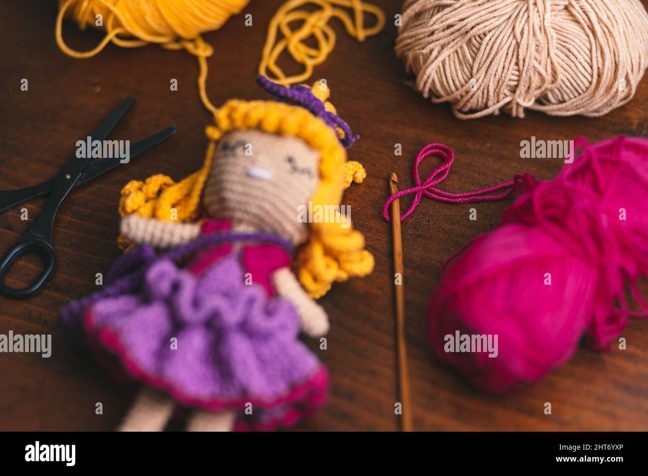 Product photo of a handmade crochet toy doll for kids with its tools ...