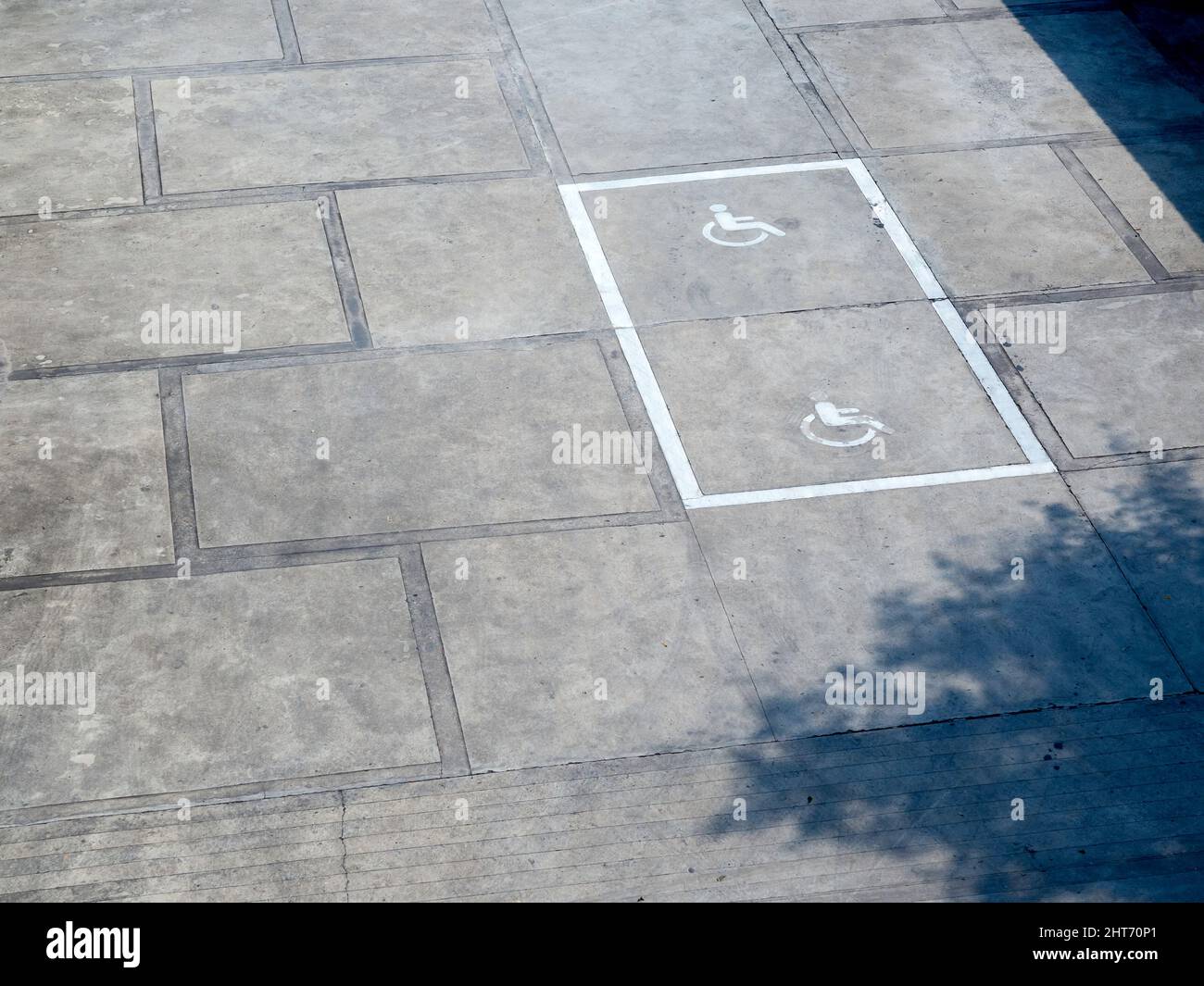 The old white handicapped icon symbol on the ground shows a sign ...