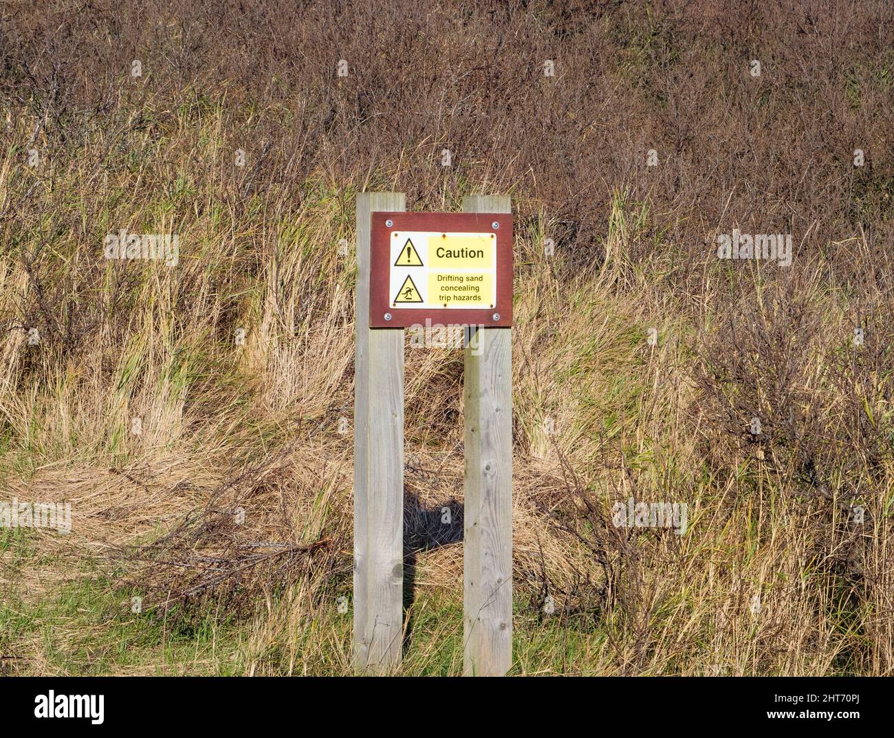 Sign warning of trip hazards in the sand dunes next to Hunstanton beach ...