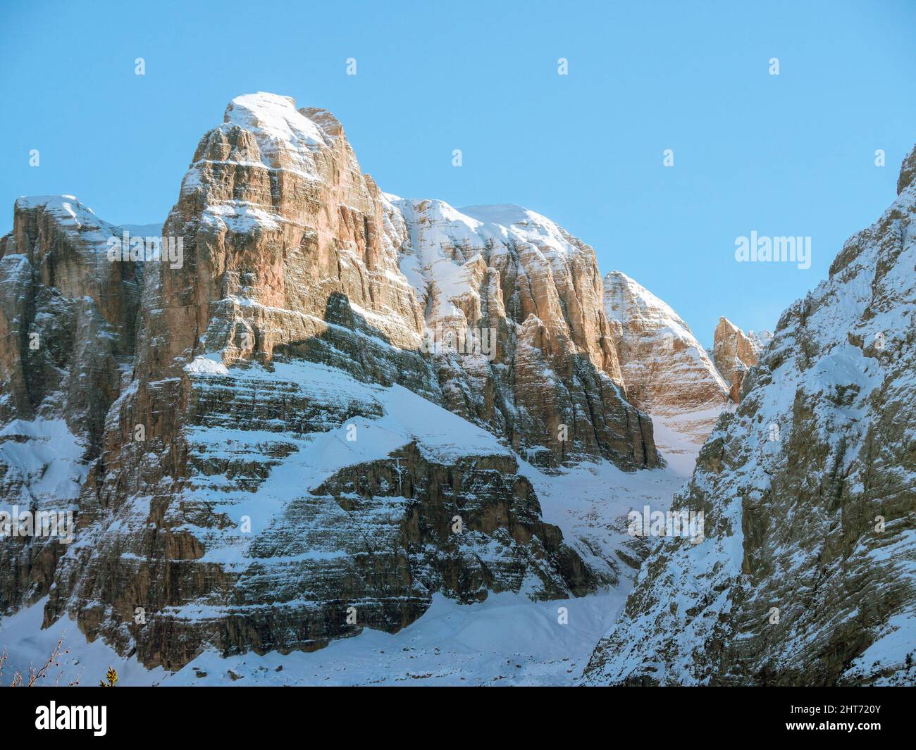 Aerial view of the Dolomites mountains in Trentino, Italy under a clear ...
