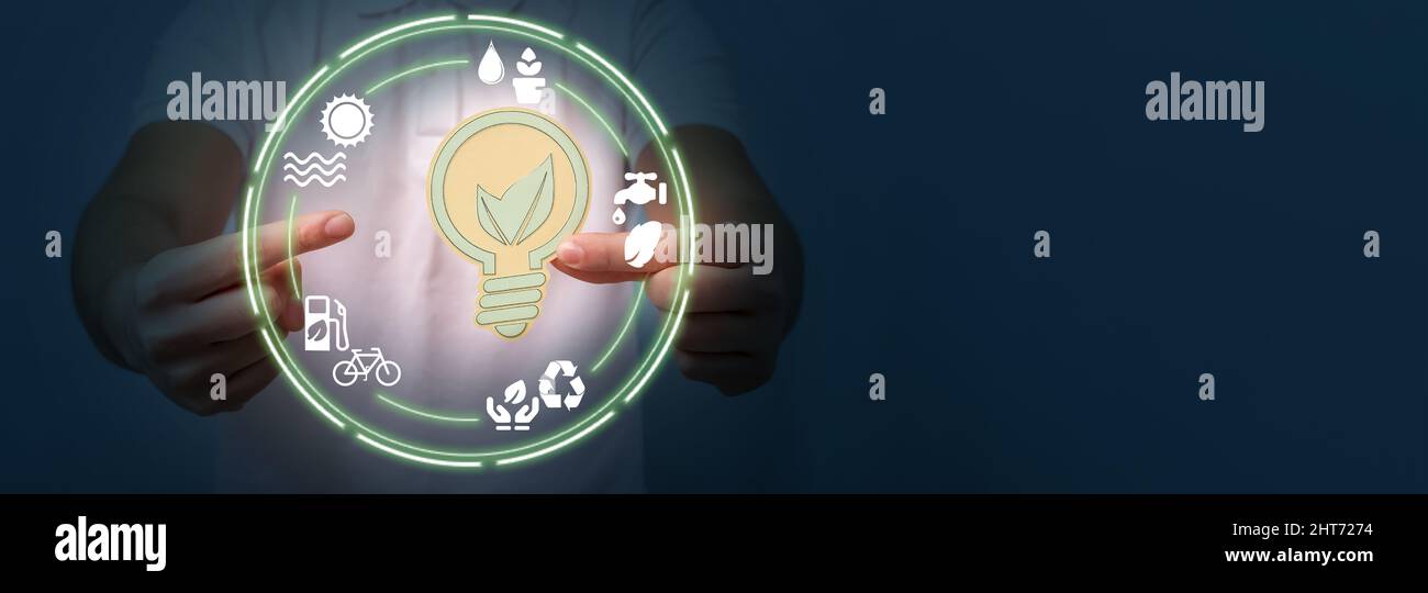Human hand holding light bulb with renewable energy symbols Stock Photo ...
