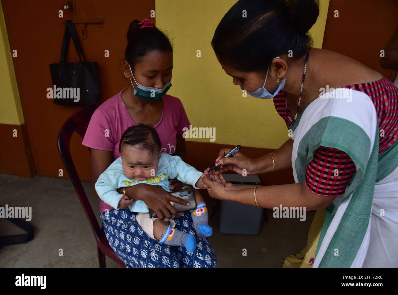 Guwahati, Guwahati, India. 27th Feb, 2022. A health worker puts ink ...